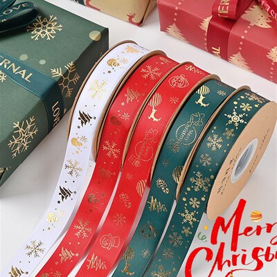 Christmas-themed gold-embossed satin ribbon gift accessory.
