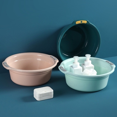 The family washes their clothes with a plastic pot and a nic