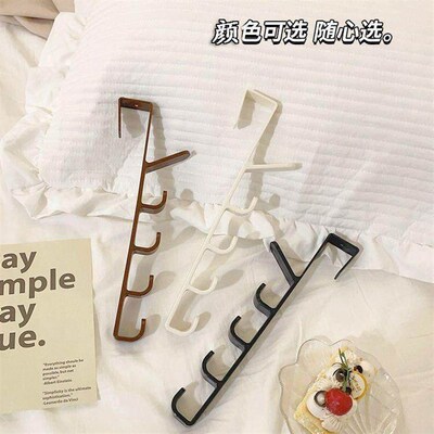 Behind the door, a long row of hooks serves as a bag hanger