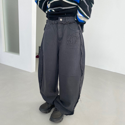 字母印花拼接流苏毛边牛仔裤