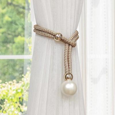 A pair of luxurious high-end pearl curtain tiebacks, suitabl