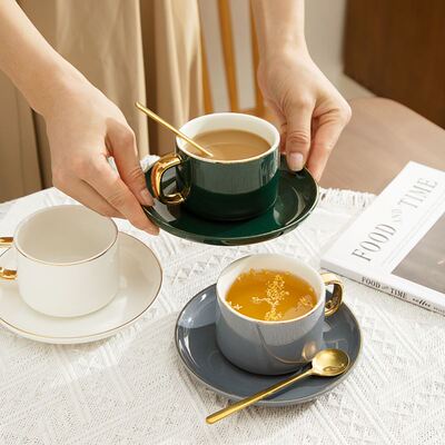 Classic ceramic coffee cup with gold handle creative design