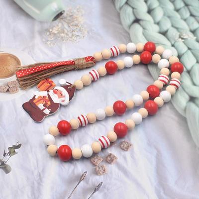2022. Santas ropes are swirling, colored wooden beads are h