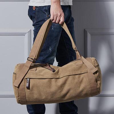 Mans travel bag with a large slanted slanted swab of handba