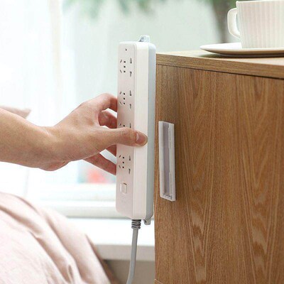 Wall-mounted power strip holder, no-drill adhesive cable man