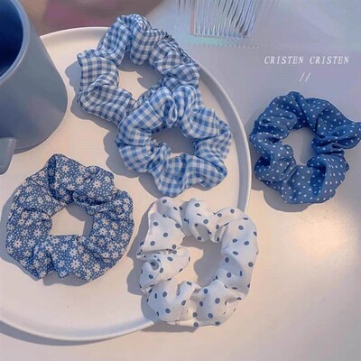 A blue and white polka dot and gingham floral fabric hair sc
