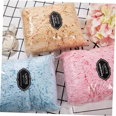 gift lined with shredded paper filling, colored packing box